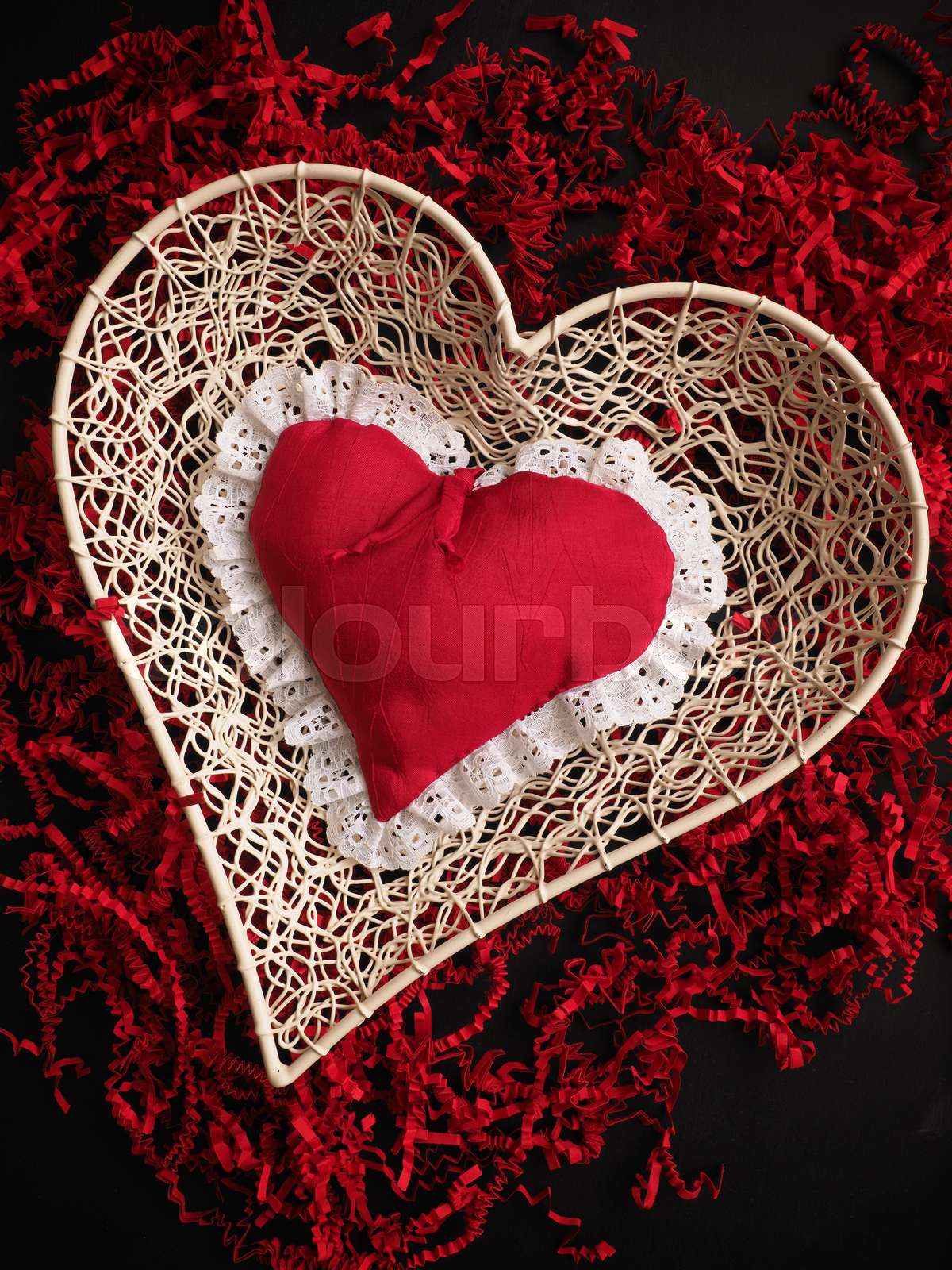 Red heart shape on shredded paper | Stock image | Colourbox