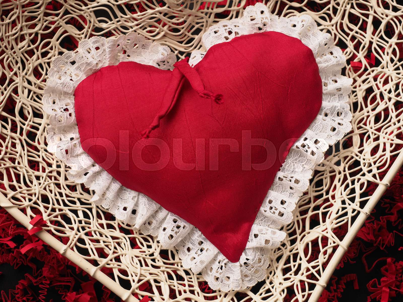 Red heart shape on shredded paper | Stock image | Colourbox