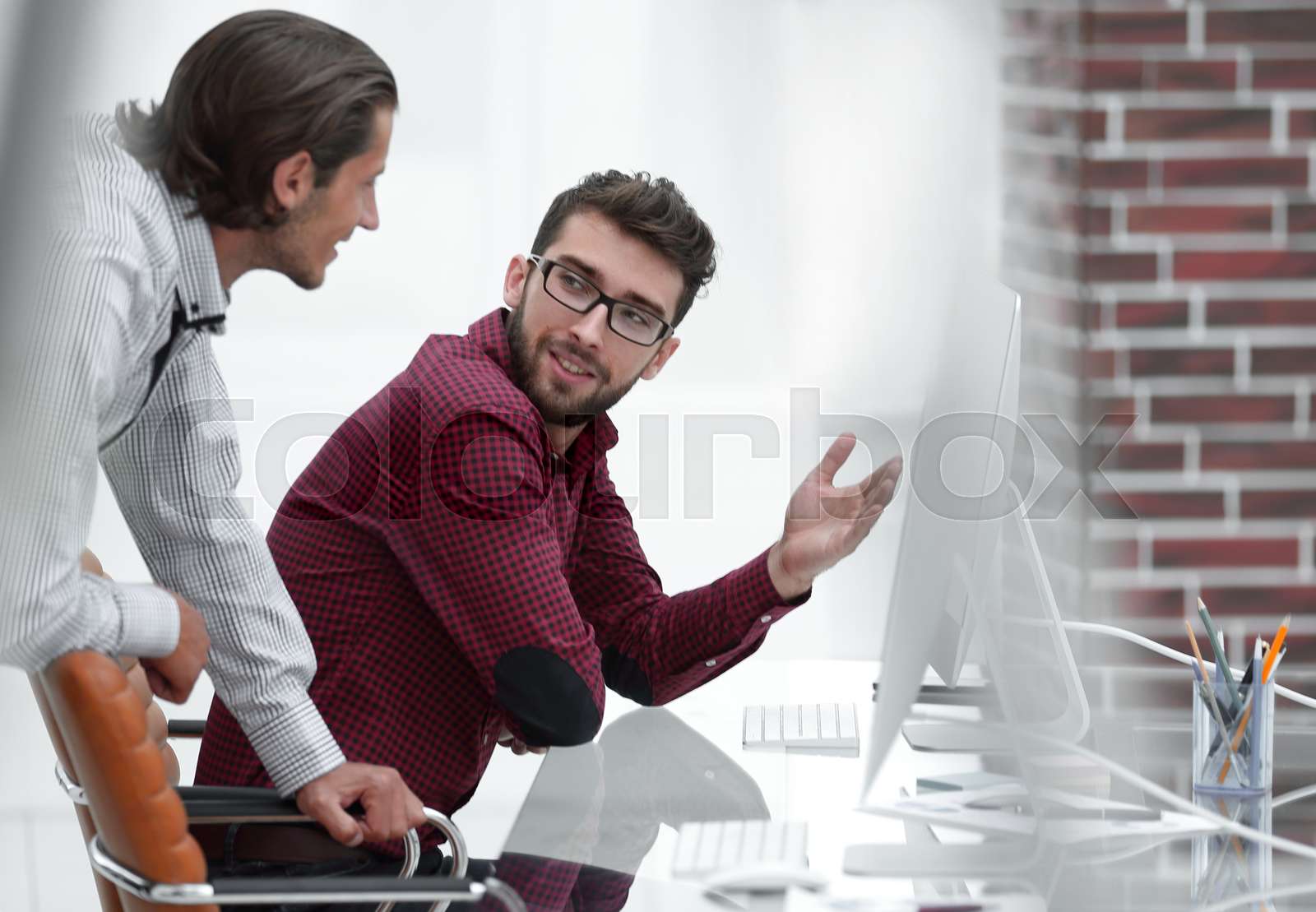 two office employee talking in the office. | Stock image | Colourbox