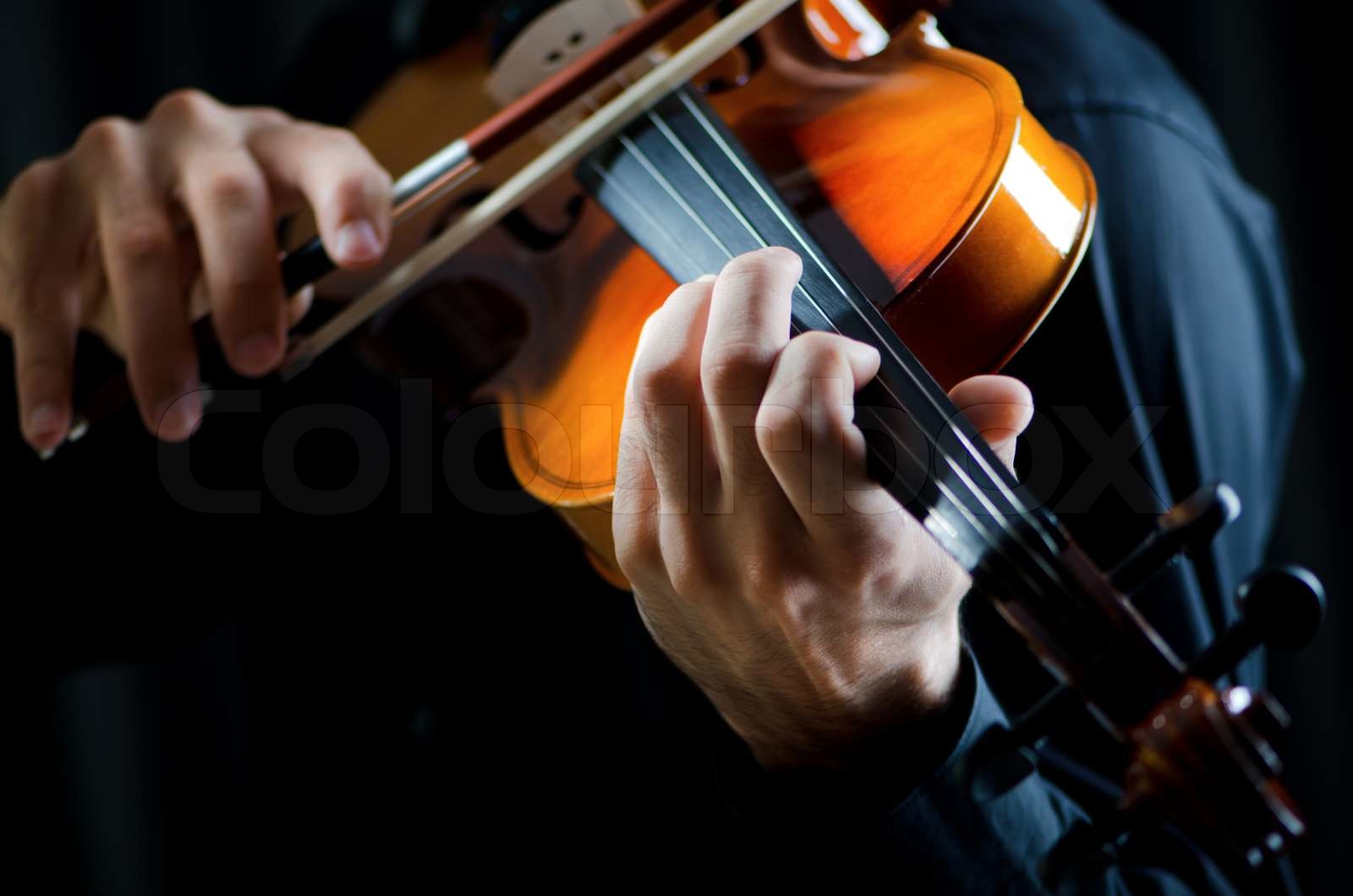 Violin player playing the intstrument | Stock image | Colourbox
