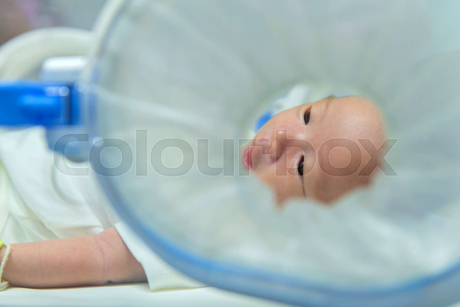 newborn baby girl get the light therapy inside incubator at hospital ...