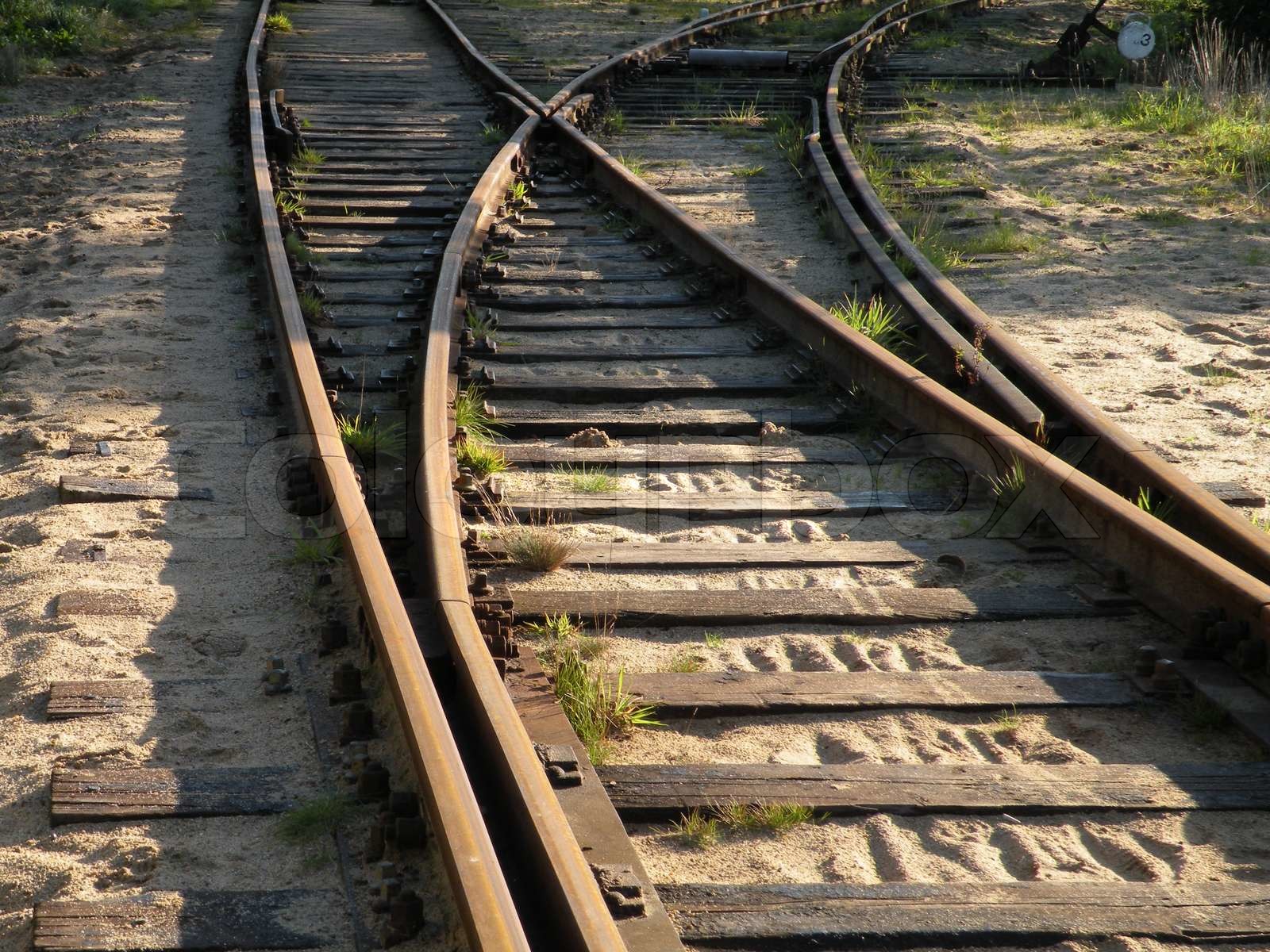 railway trails crossing close up in sunshine | Stock image | Colourbox