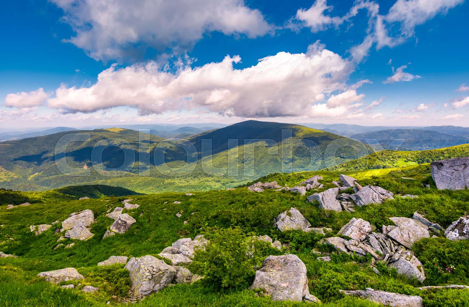 boulders on grassy hill in summer | Stock image | Colourbox
