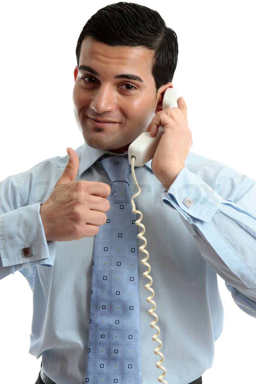 A Businessman On A Telephone Call And With Thumbs Up Success Approval a-businessman-on-a-telephone-call-and-with-thumbs-up-success-approval