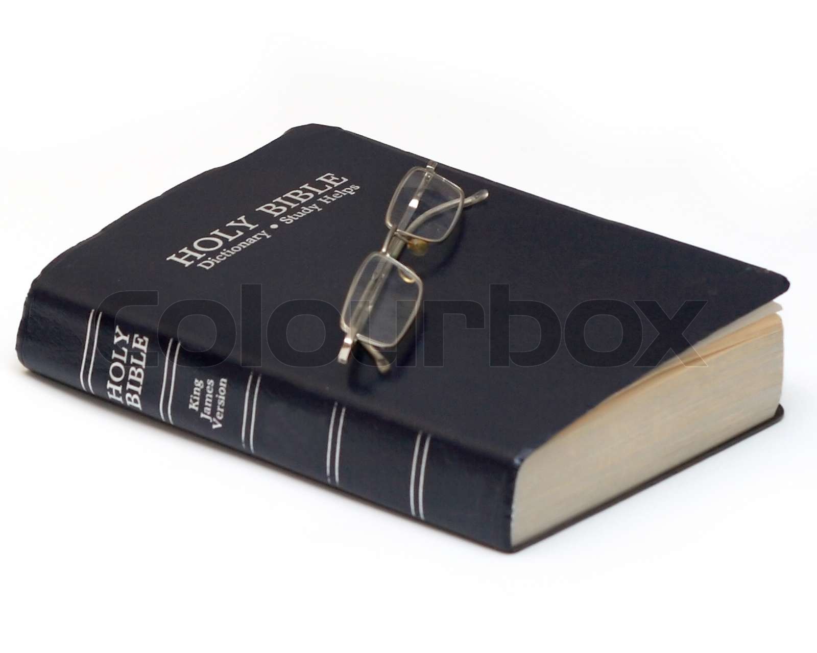 Holy Bible with eyeglasses isolated on white | Stock image | Colourbox