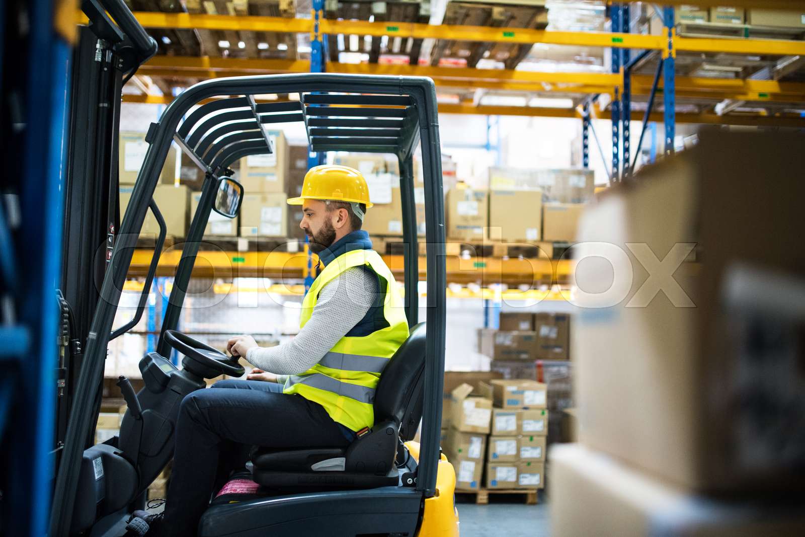 Warehouse man worker with forklift. | Stock image | Colourbox