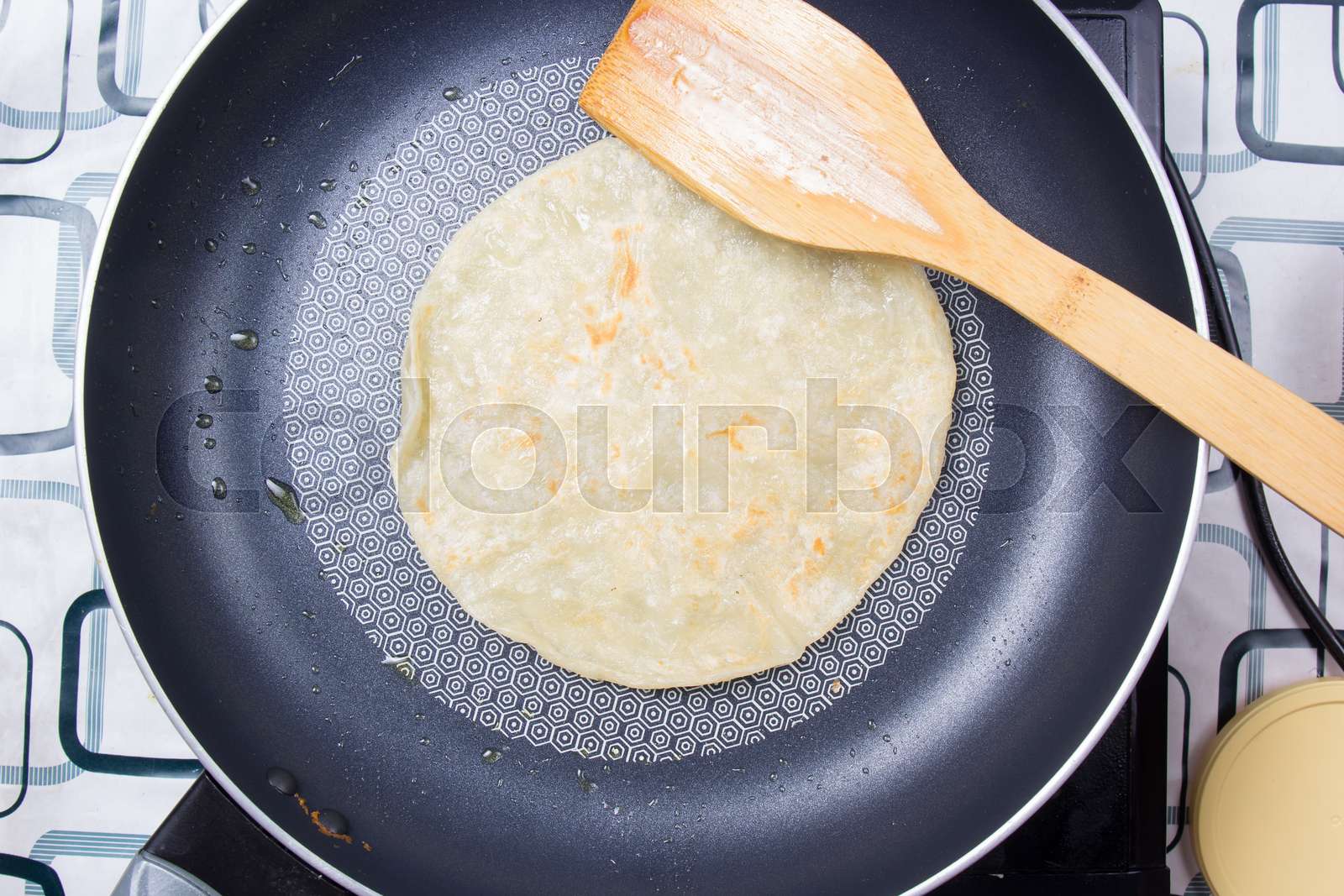 Chef cooking roti in the pan home mate style | Stock image | Colourbox