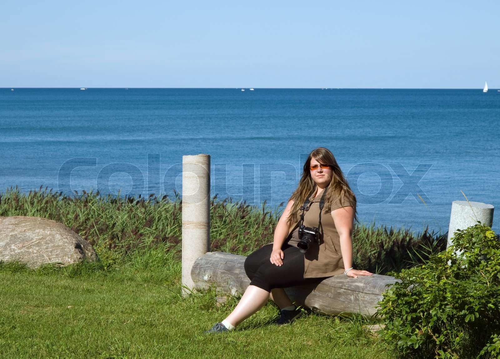 Young lady sitting on the bank | Stock image | Colourbox