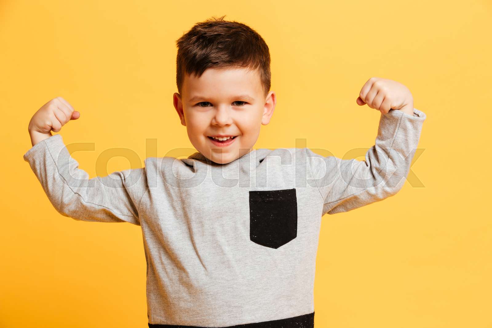 Little boy child showing biceps. | Stock image | Colourbox