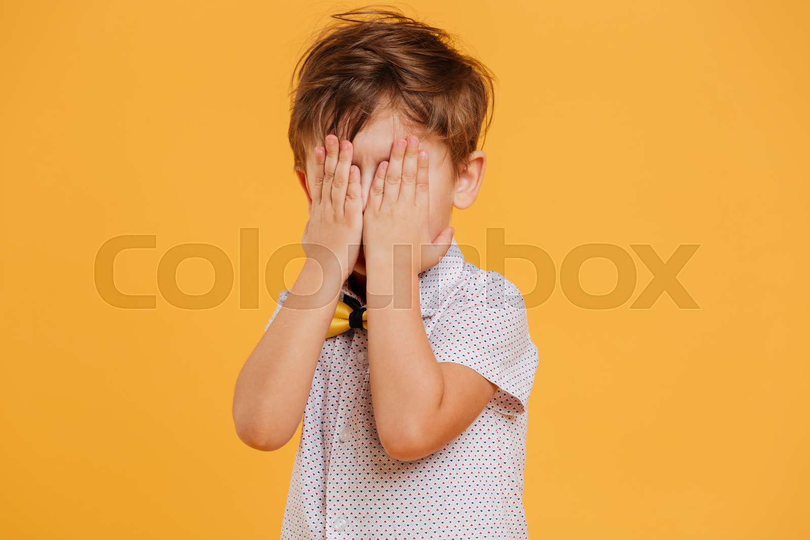Little boy child covering face with hands. | Stock image | Colourbox