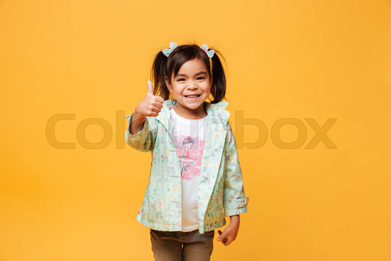 Happy little girl child standing isolated | Stock image | Colourbox