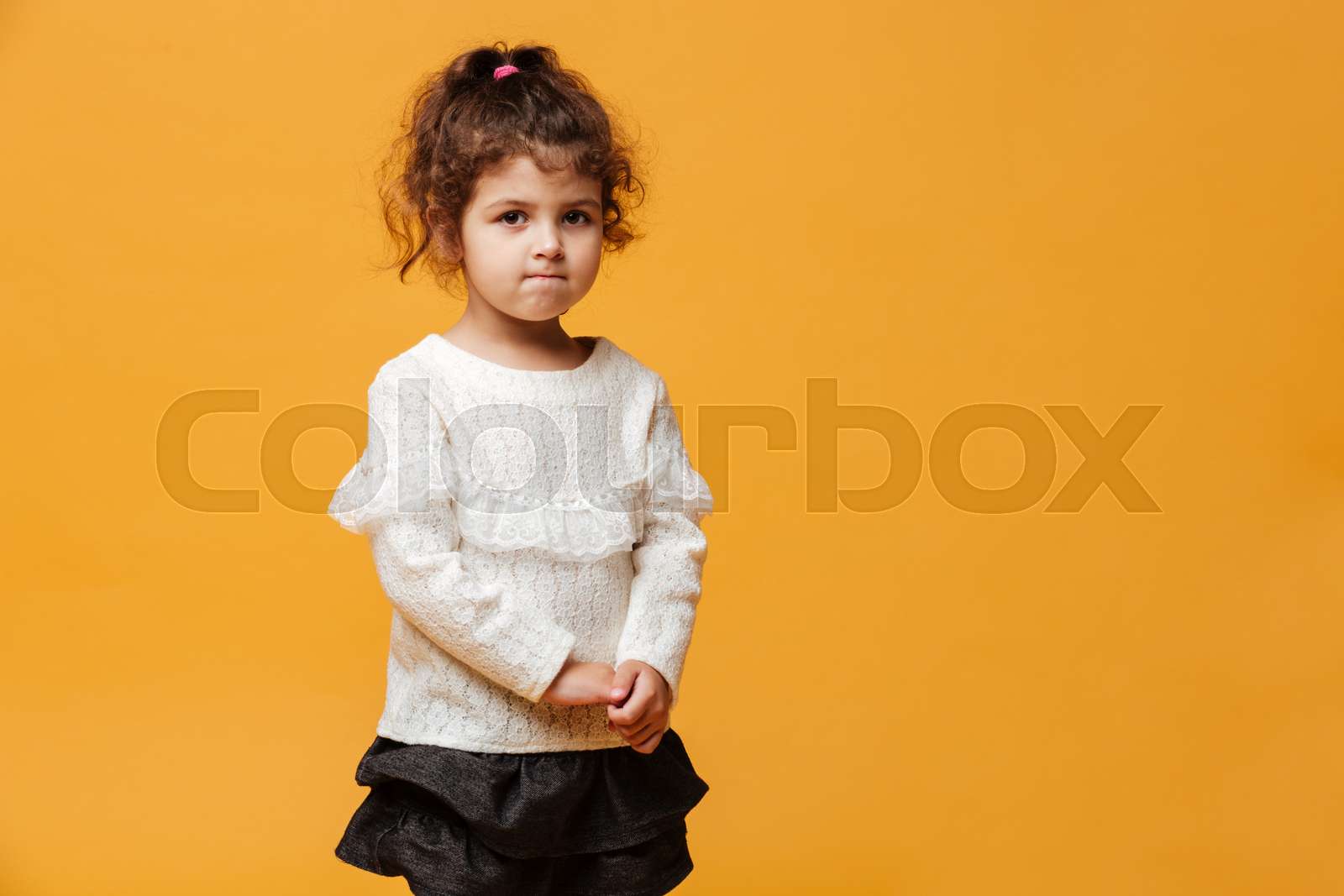 Confused little girl child standing isolated | Stock image | Colourbox