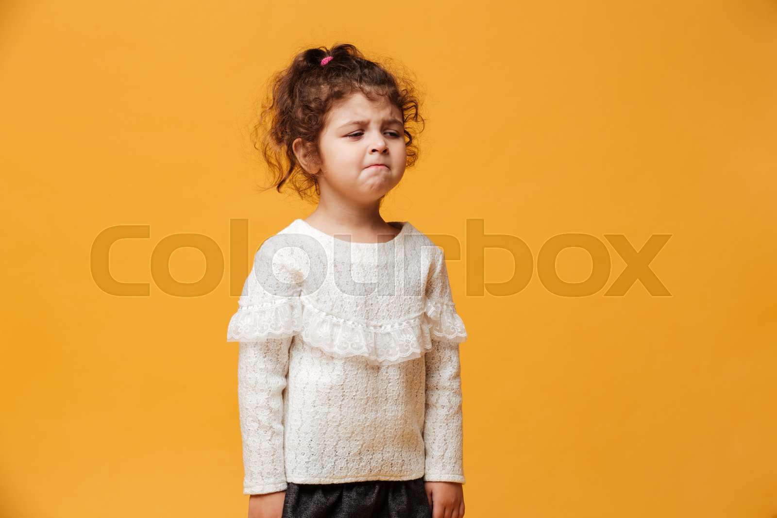 Sad little girl child cry standing isolated | Stock image | Colourbox