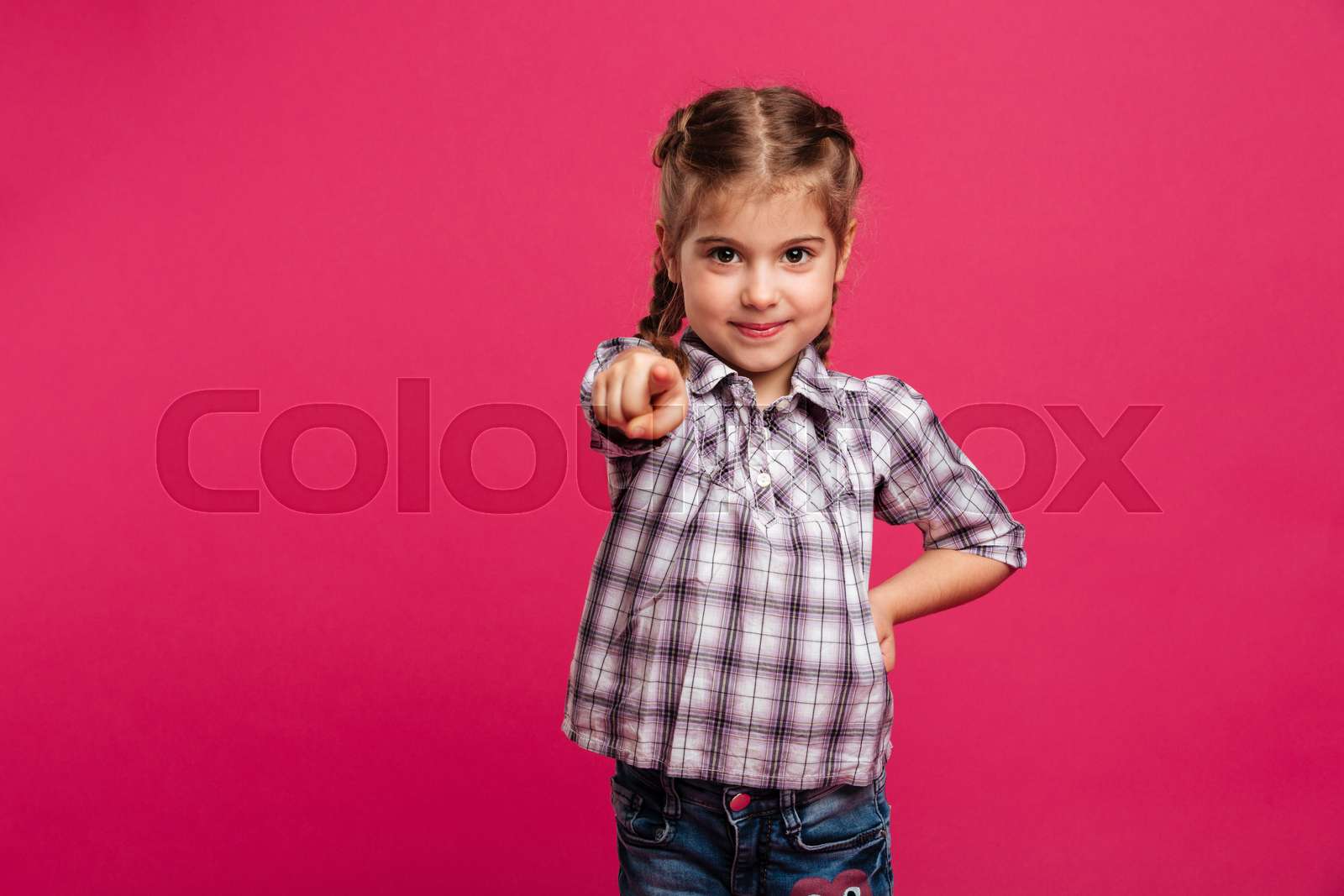 Cheerful little girl child pointing to you. | Stock image | Colourbox