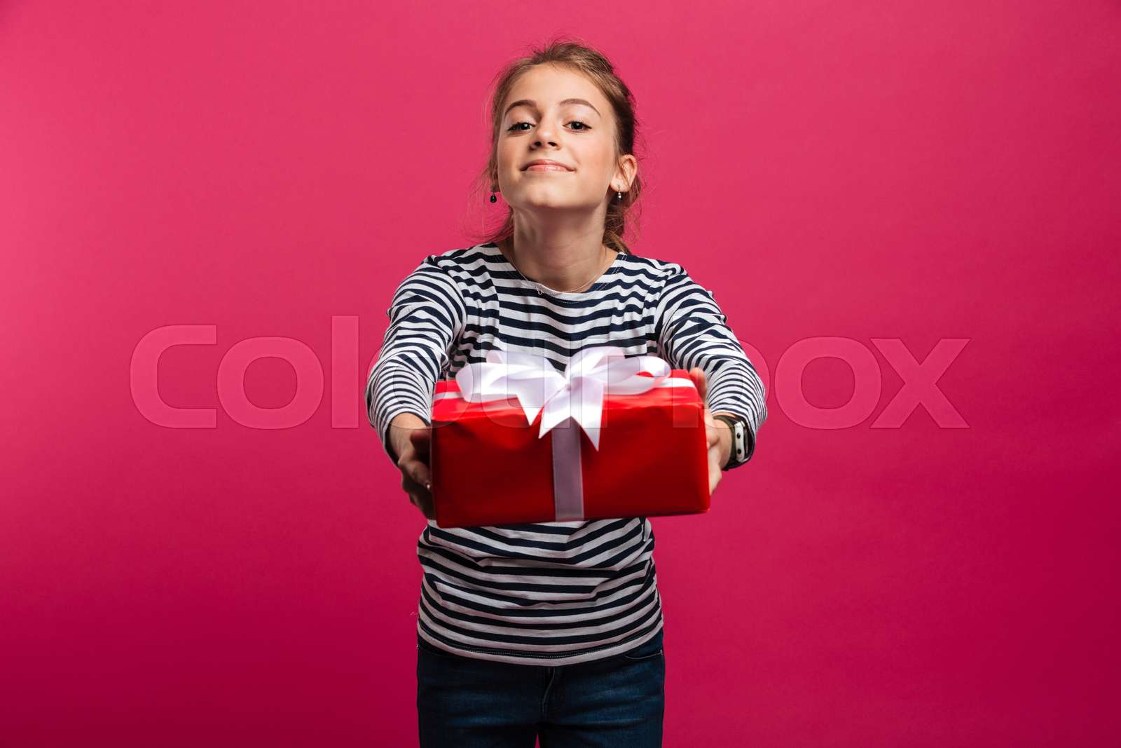 Smiling teenage girl give you a gift surprise box | Stock image | Colourbox