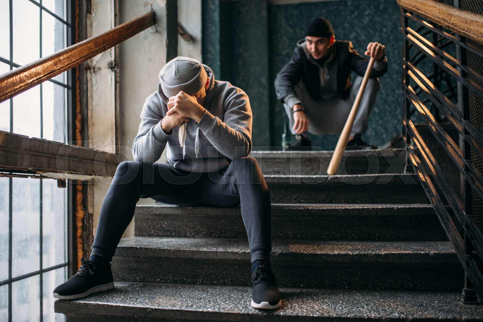 Two male gangsters are sitting on the stairs | Stock image | Colourbox