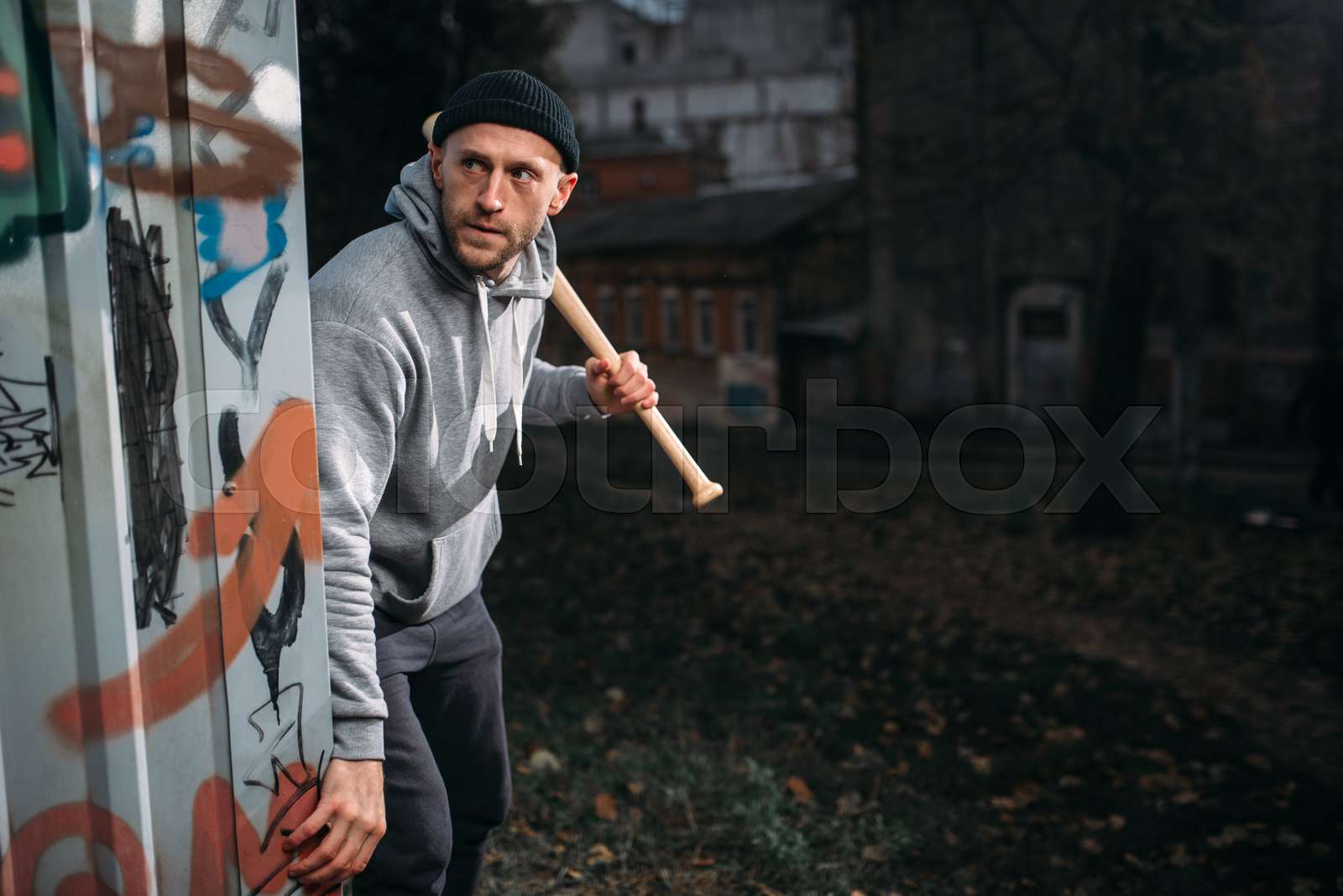 Male robber with baseball bat strikes fear | Stock image | Colourbox