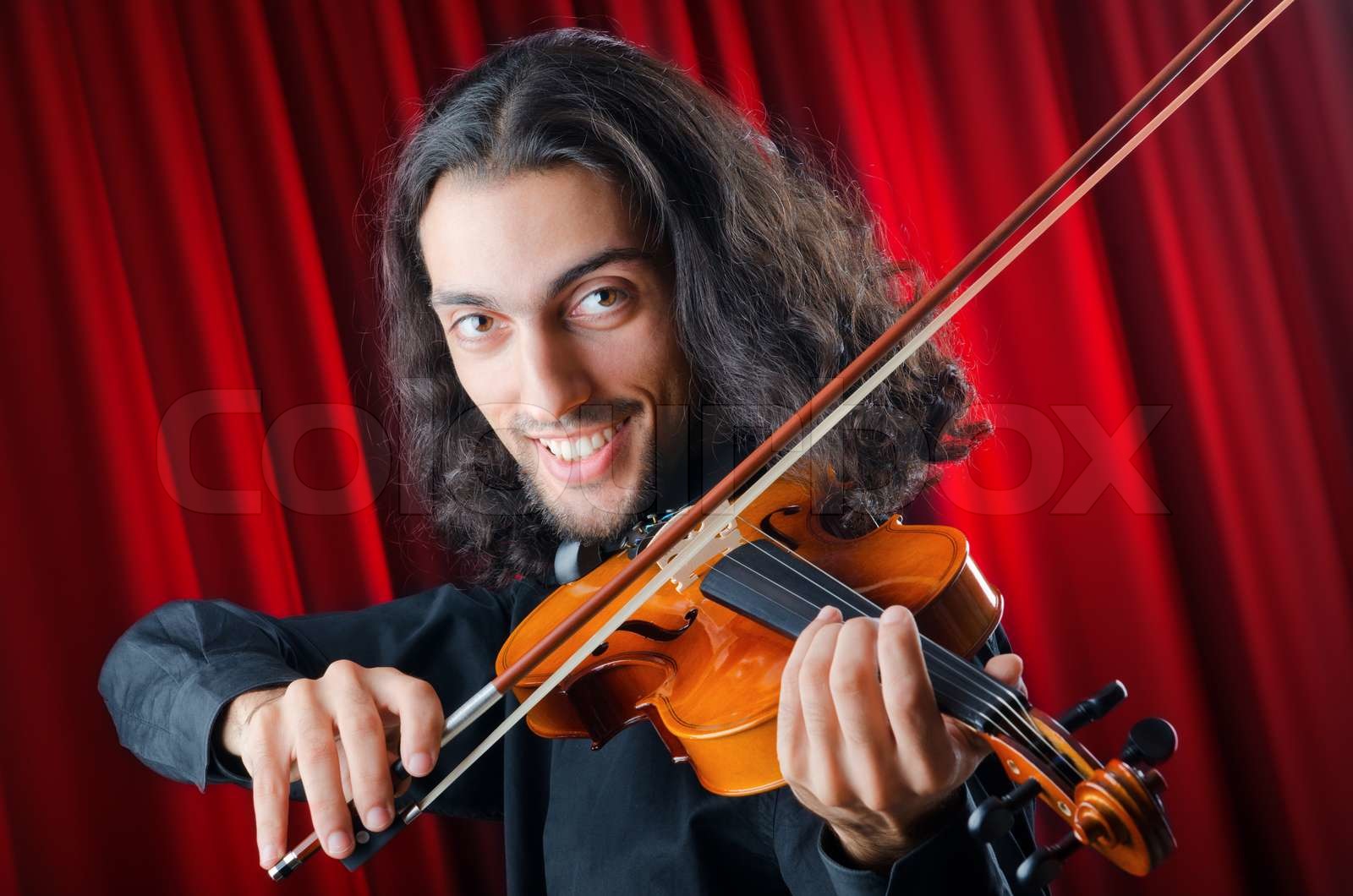 Violin player playing the intstrument | Stock image | Colourbox
