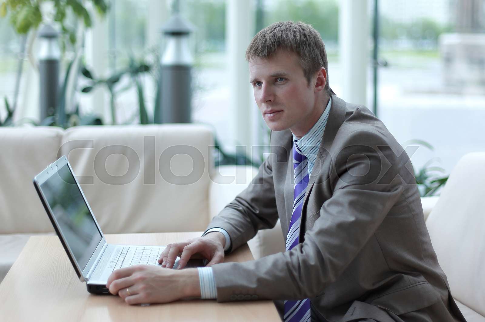 Young employee looking at computer monitor during working day | Stock ...
