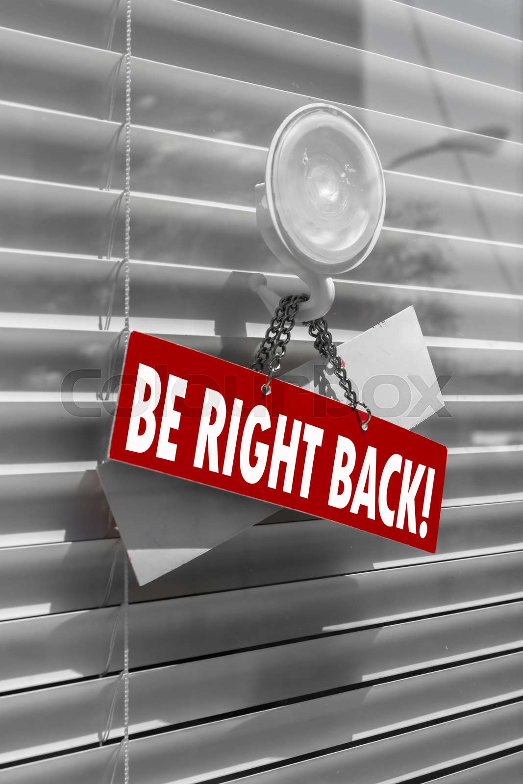 A sign saying "be right back" on a glass door | Stock image | Colourbox