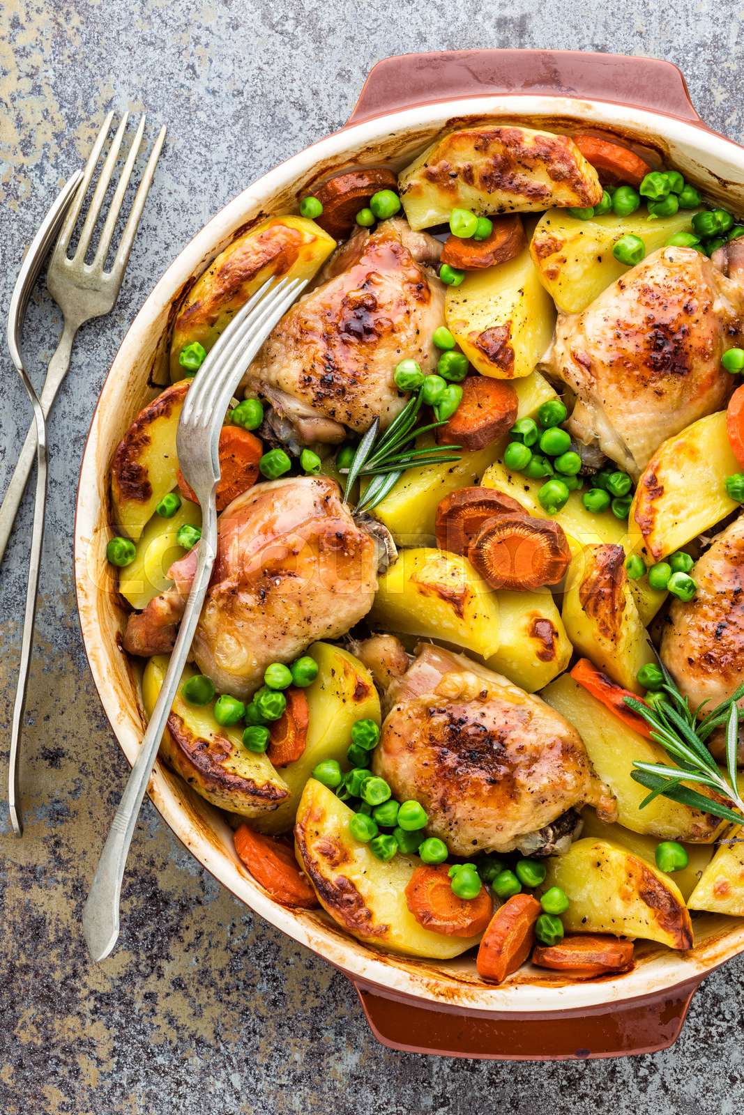 Chicken meat, thighs baked with potato, carrot and green peas | Stock ...