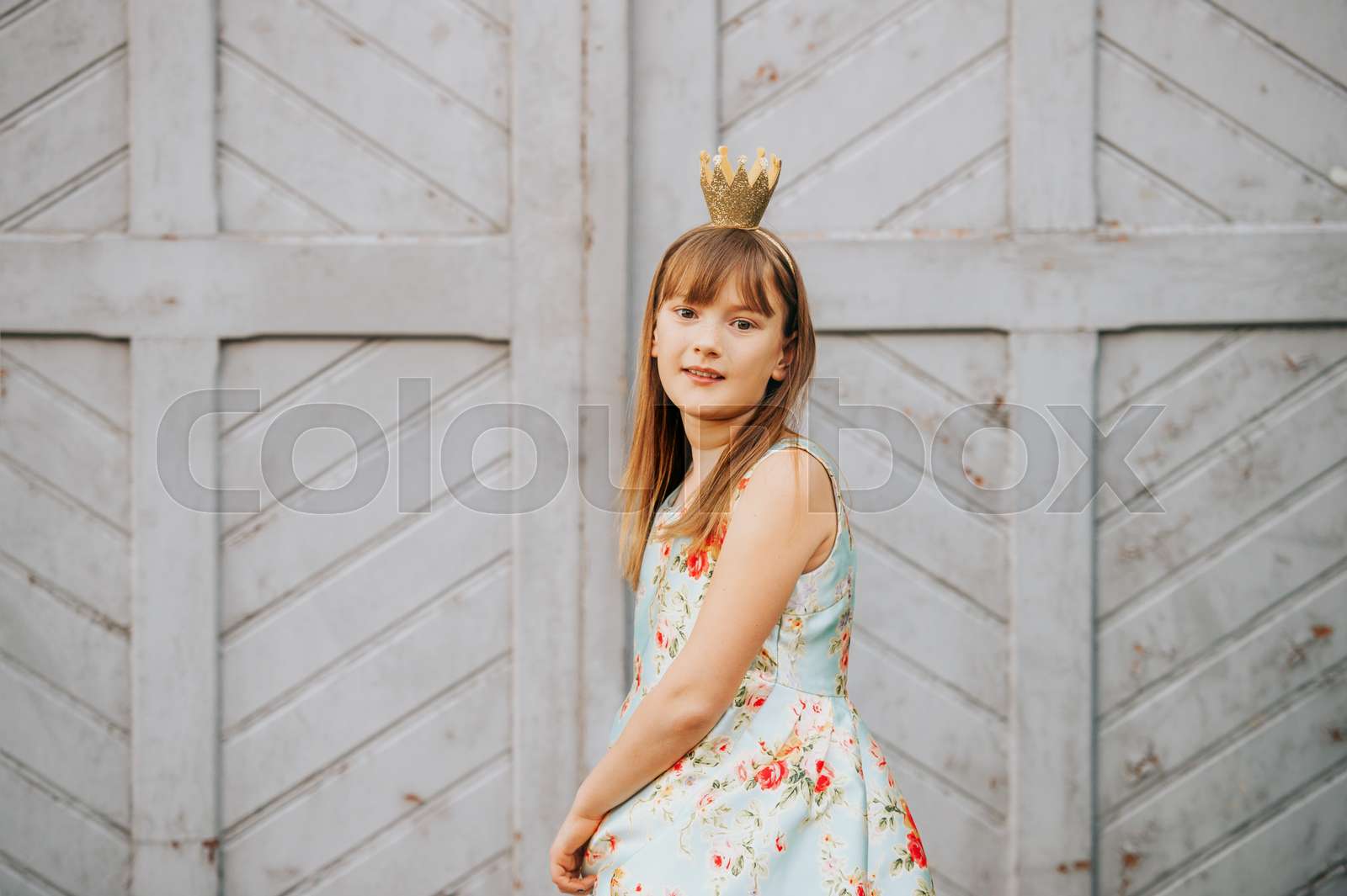 Young little 9-10 year old girl, wearing beautiful dress and gold crown ...