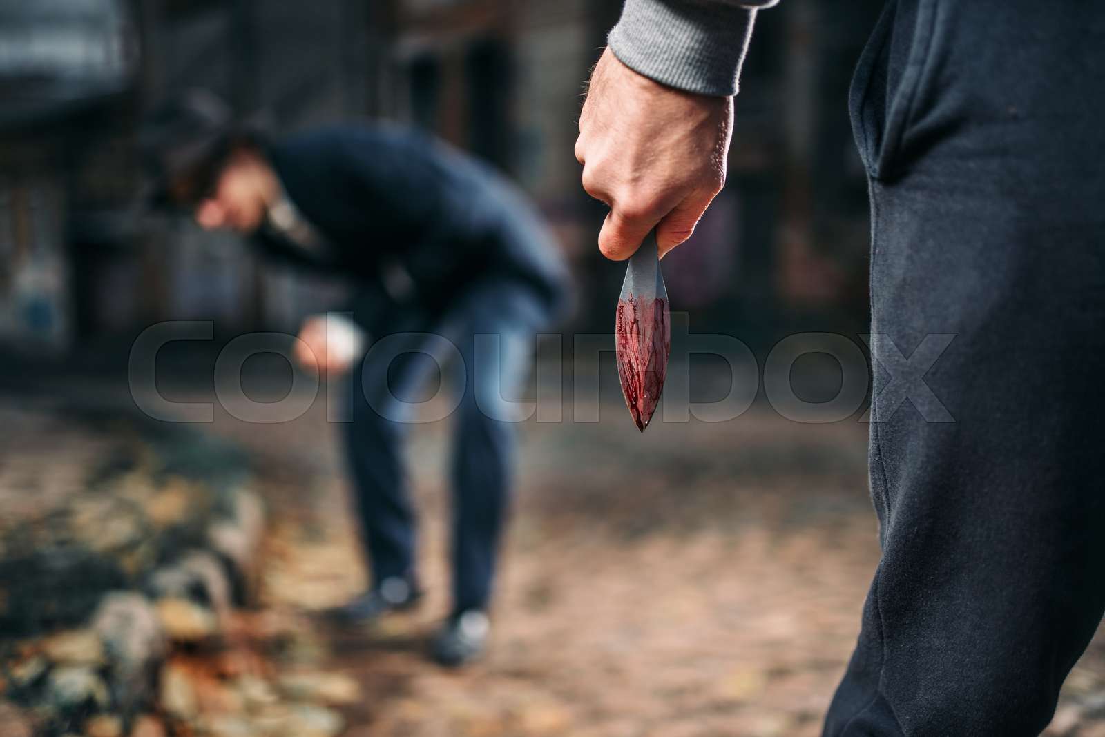 Robber stabbed victim, bloodied murder weapon | Stock image | Colourbox