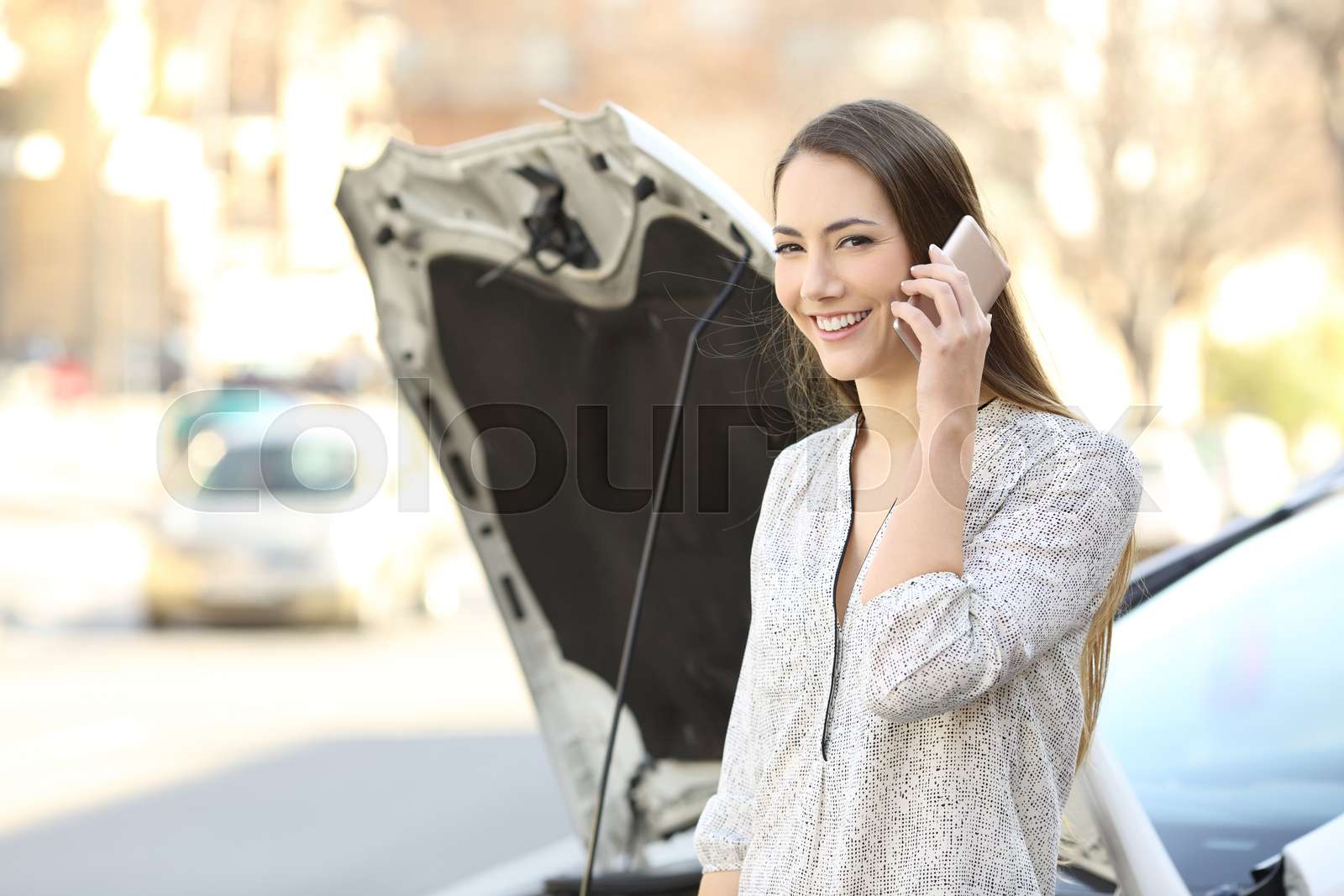 Happy driver calling insurance and looking at you - Stock Image ...