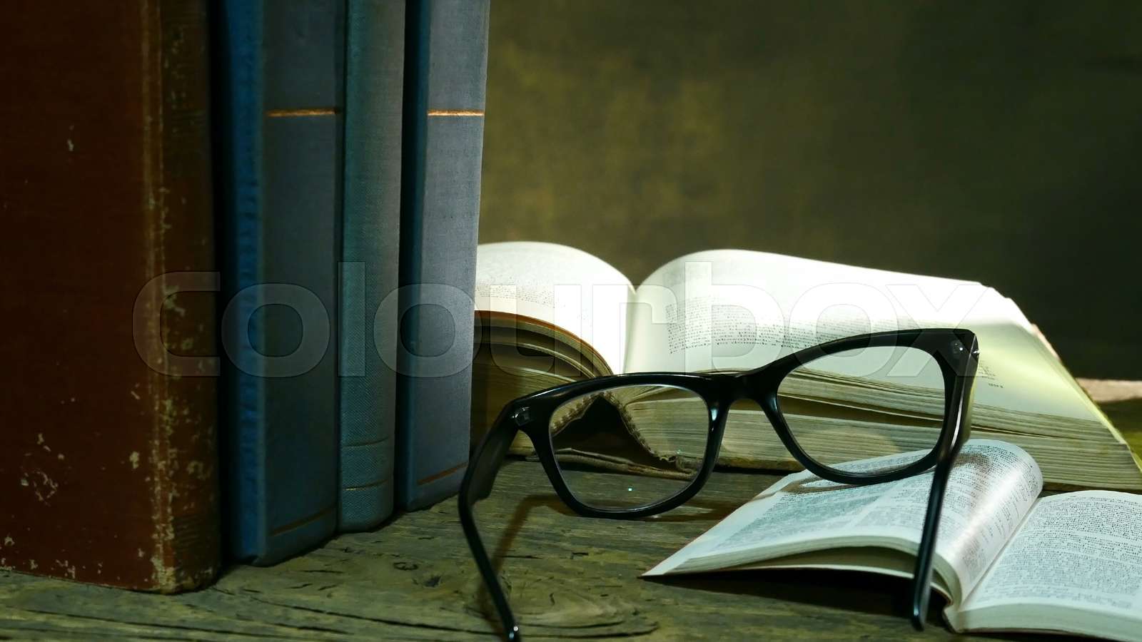 Open Bible with Glasses on the Old Table. | Stock image | Colourbox