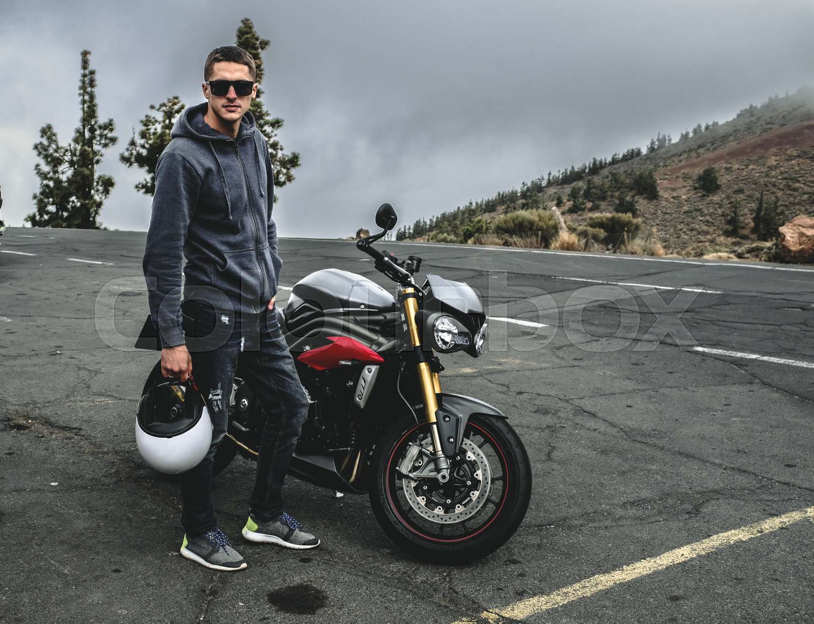 rider stand on a mountain next to motorcycle | Stock image | Colourbox
