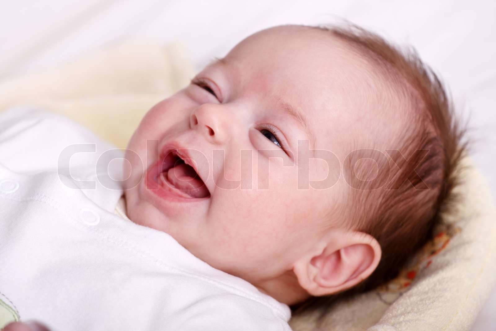 Cute baby girl laughing with toothless smile | Stock image | Colourbox