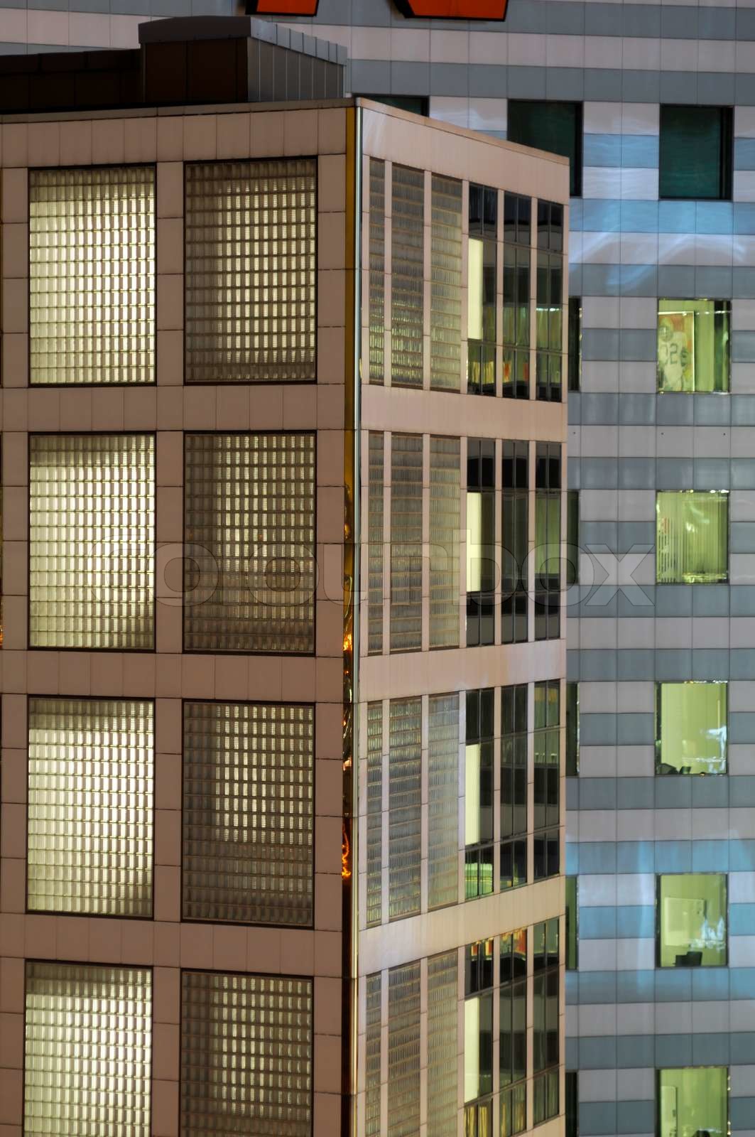 This photograph represent a high-rise office building illuminated at ...