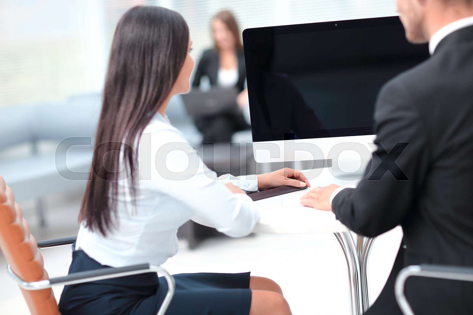 rear view.two successful employee sitting behind a Desk | Stock image ...