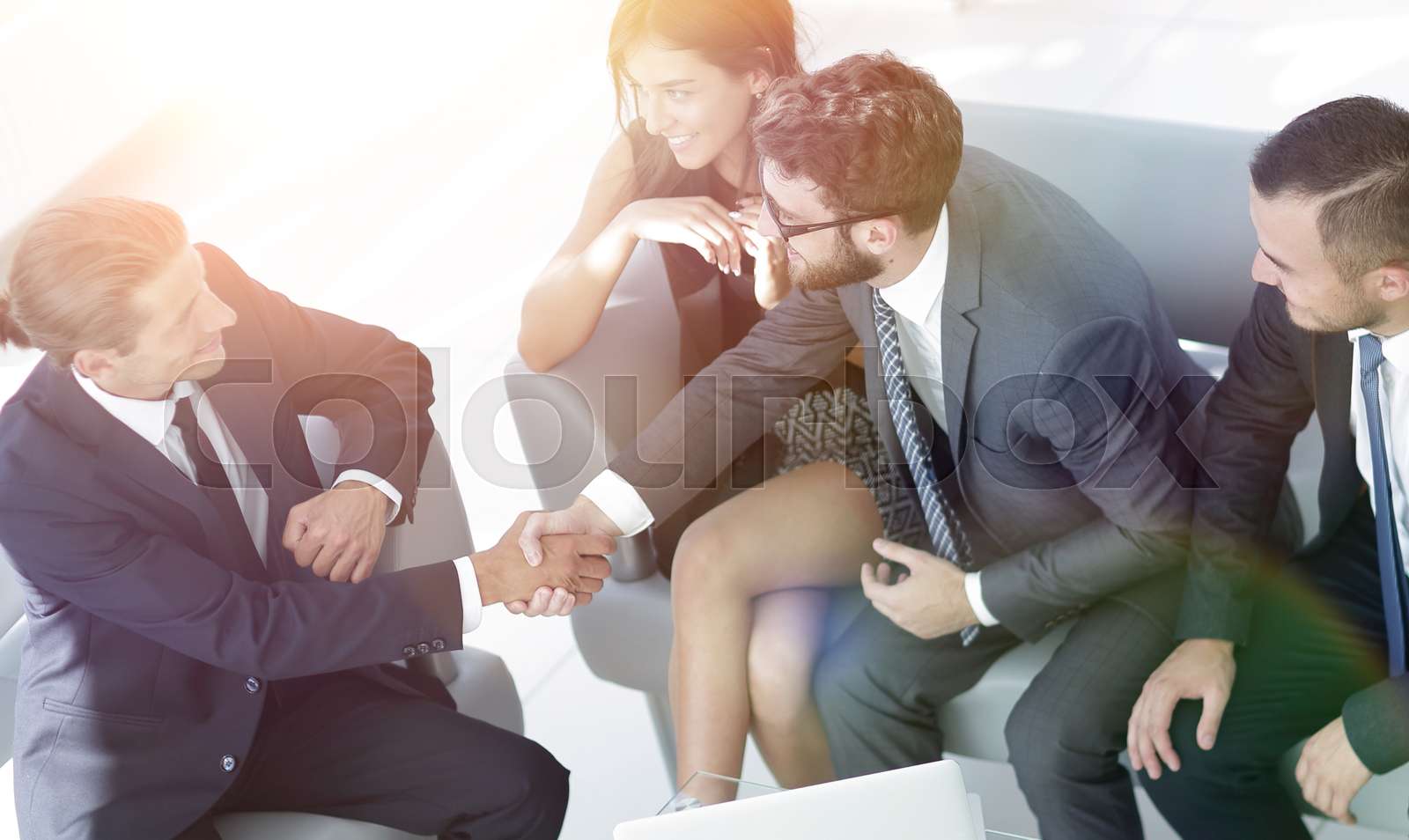 handshake Manager and the client sitting in the office lobby. | Stock ...
