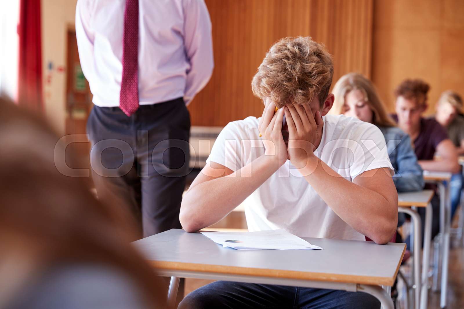Anxious Teenage Student Sitting Examination In School Hall | Stock ...