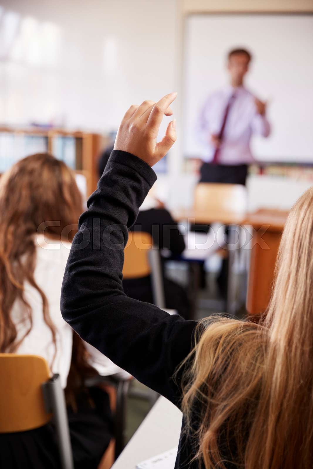 Female Student Raising Hand To Ask Question In Classroom | Stock image ...
