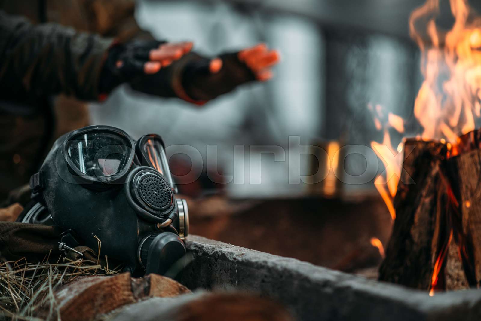 Stalker, male person warms his hands on fire | Stock image | Colourbox