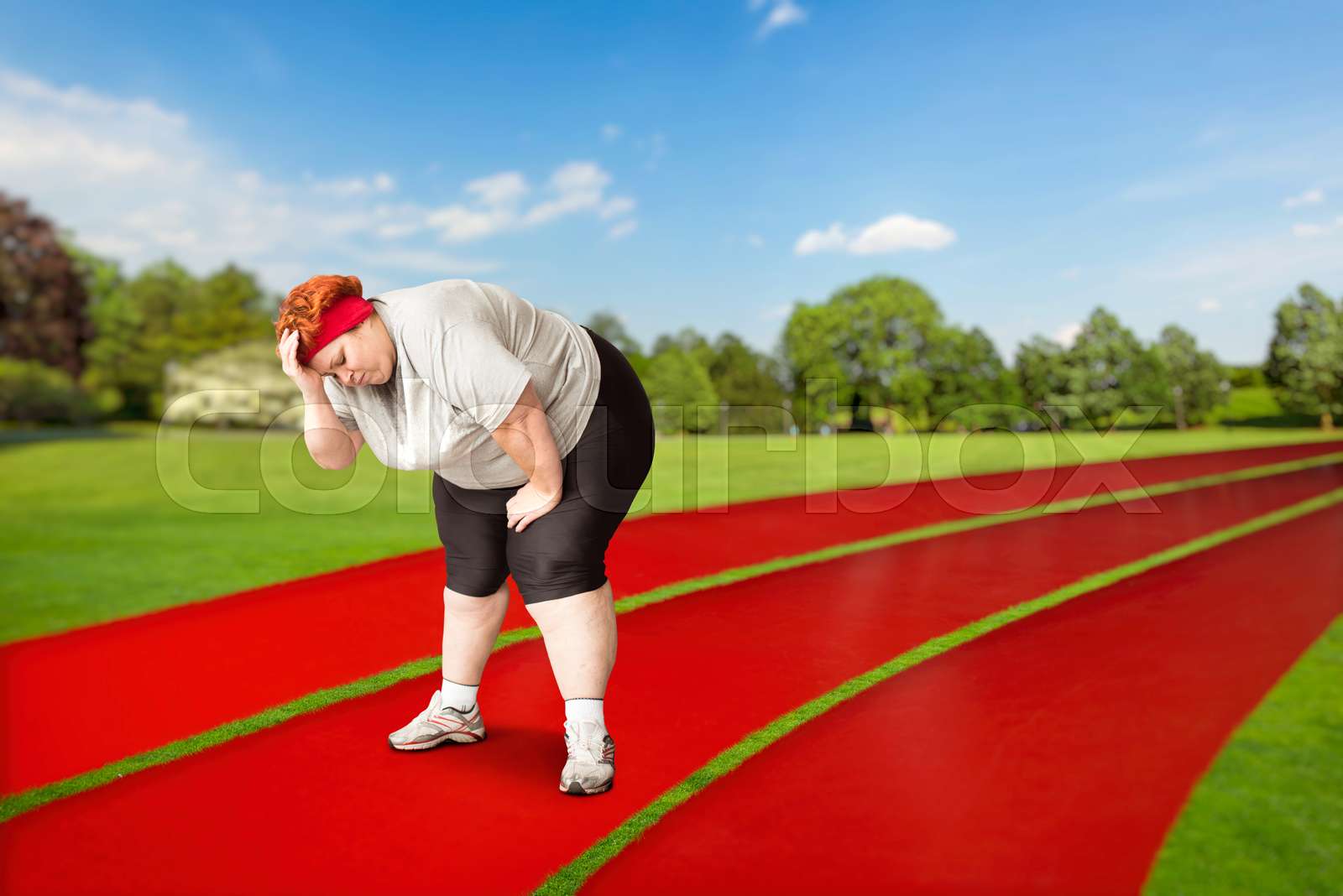 Overweight tired female runner on a jogging track | Stock image | Colourbox