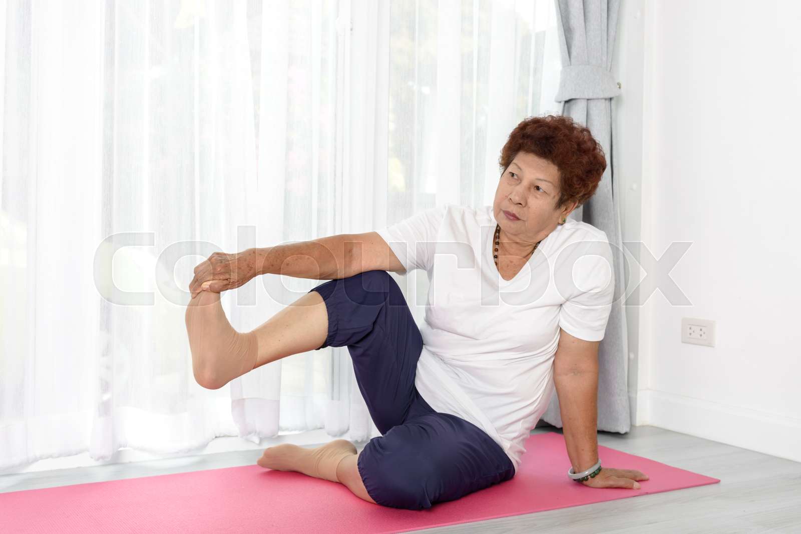 Asian senior woman doing exercise at home. | Stock image | Colourbox