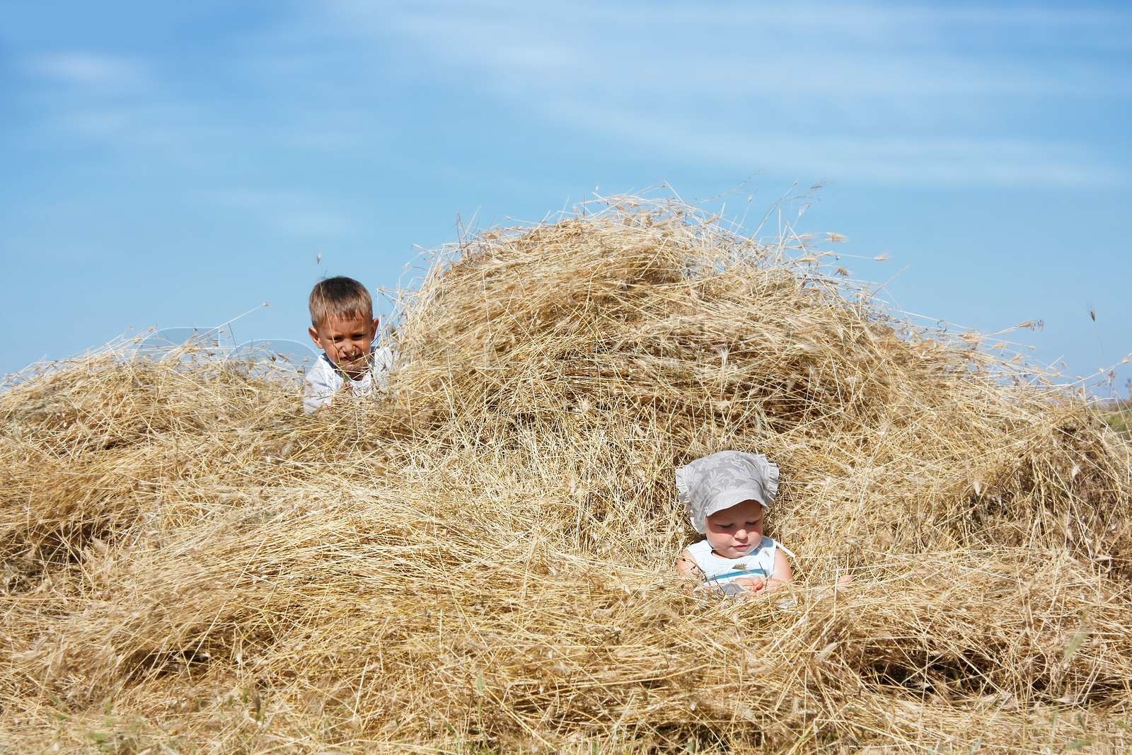 two children playing in haystack | Stock image | Colourbox