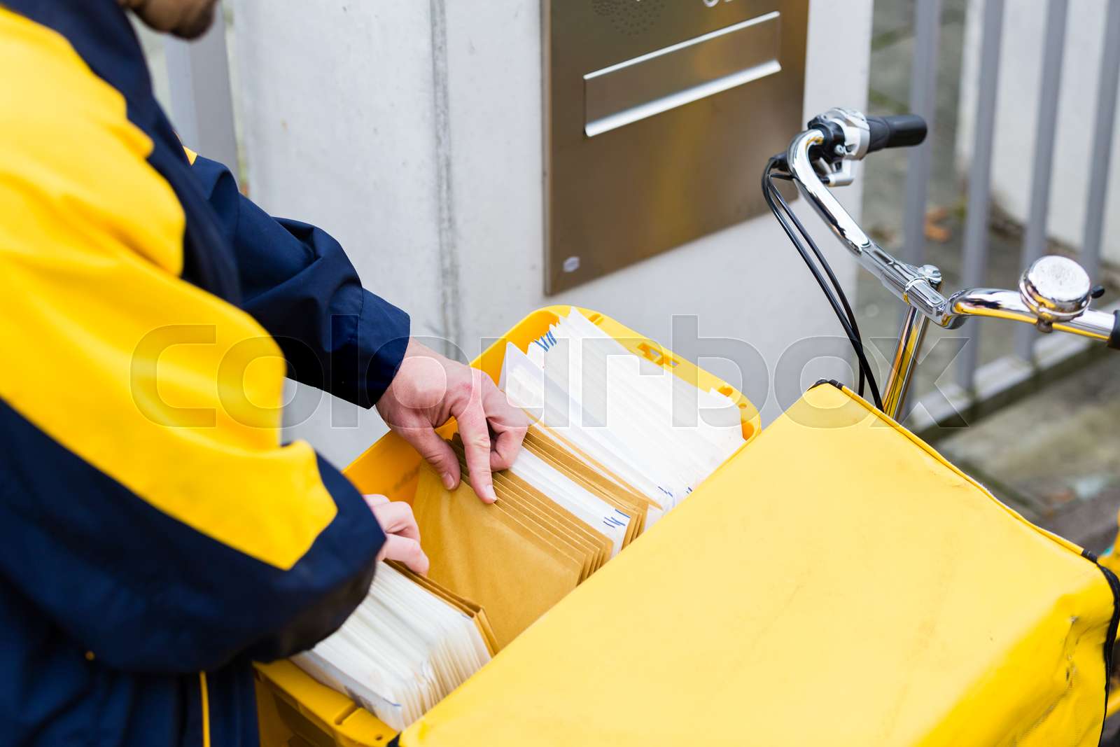 Postman delivering letters to mailbox of recipient | Stock image ...