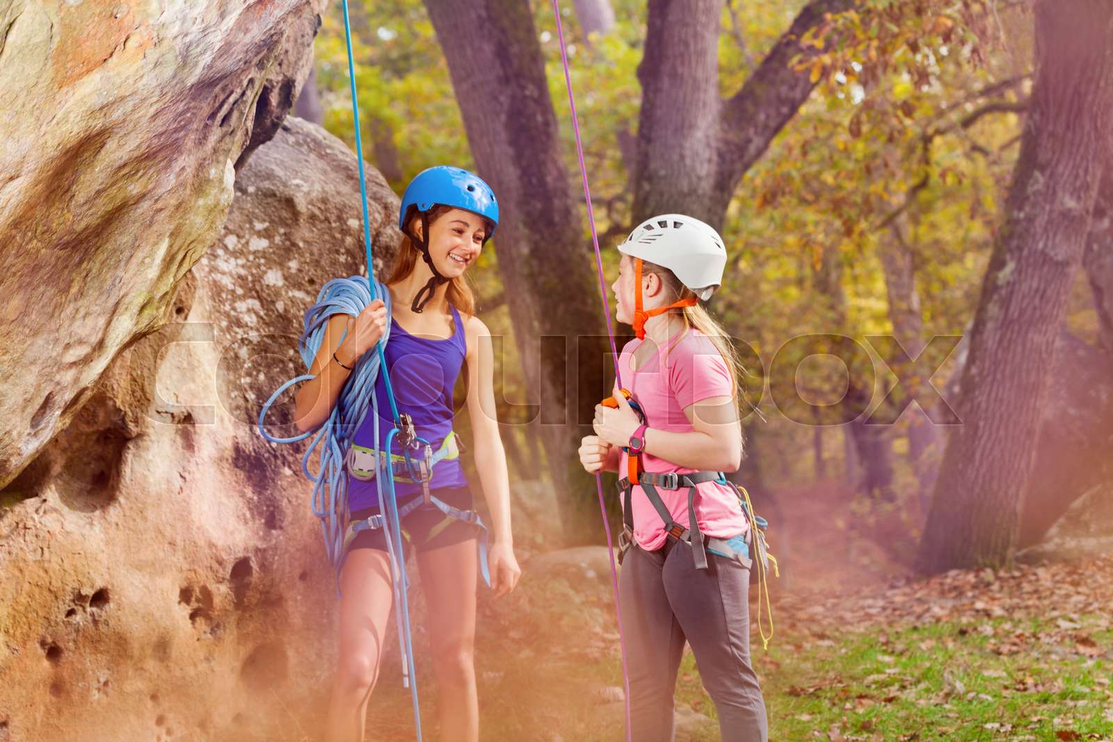Rock climbing trainer and girl in special outfit | Stock image | Colourbox