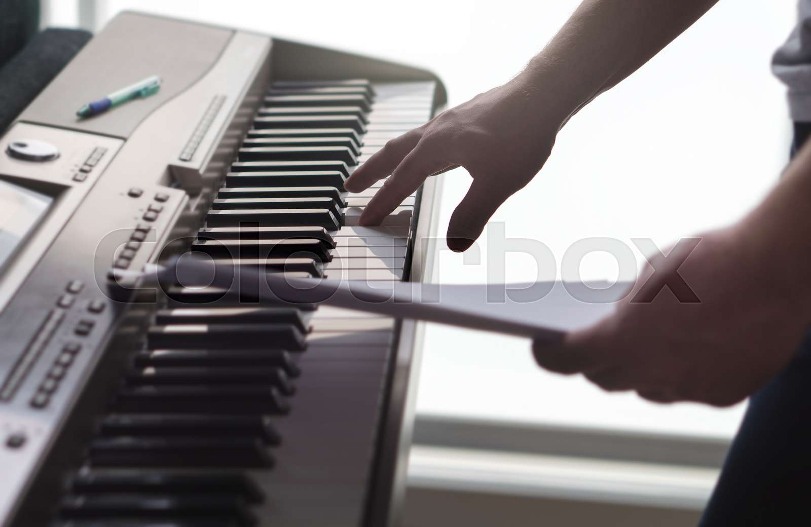 One single finger pressing key on piano. | Stock image | Colourbox