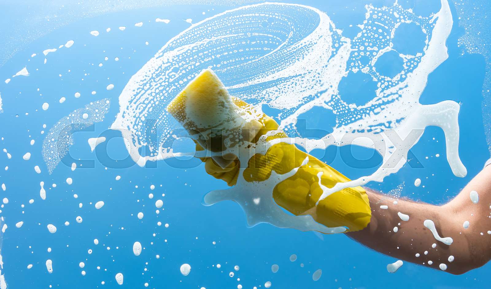 a window washer soaps up a window for window washing | Stock image ...