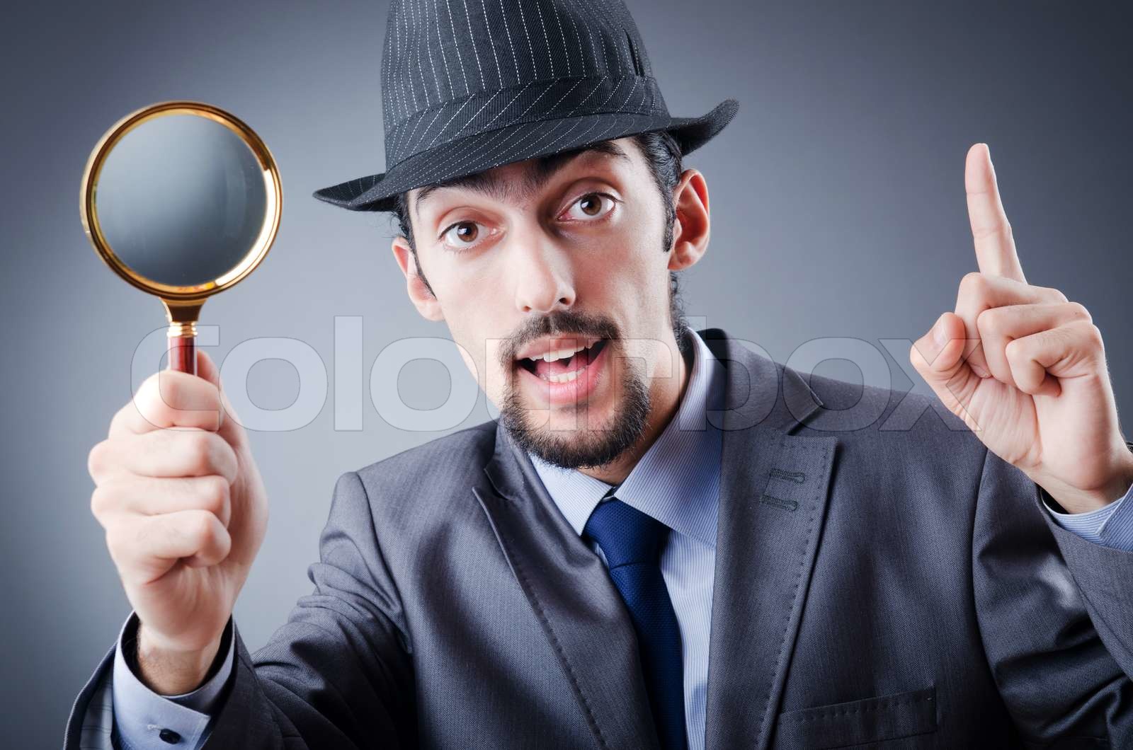 Detective and magnifying glass | Stock image | Colourbox