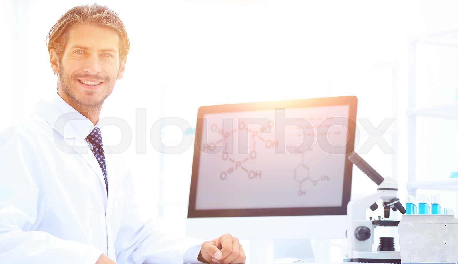 Portrait of a male scientist with a monitor looking at the camer ...