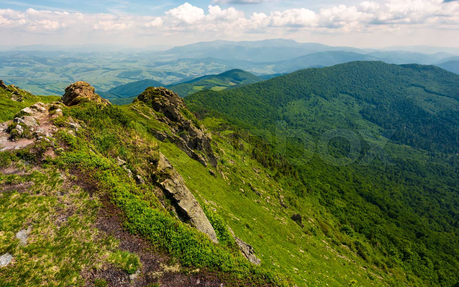 grassy slopes of mountain ridge with rocky cliffs | Stock image | Colourbox