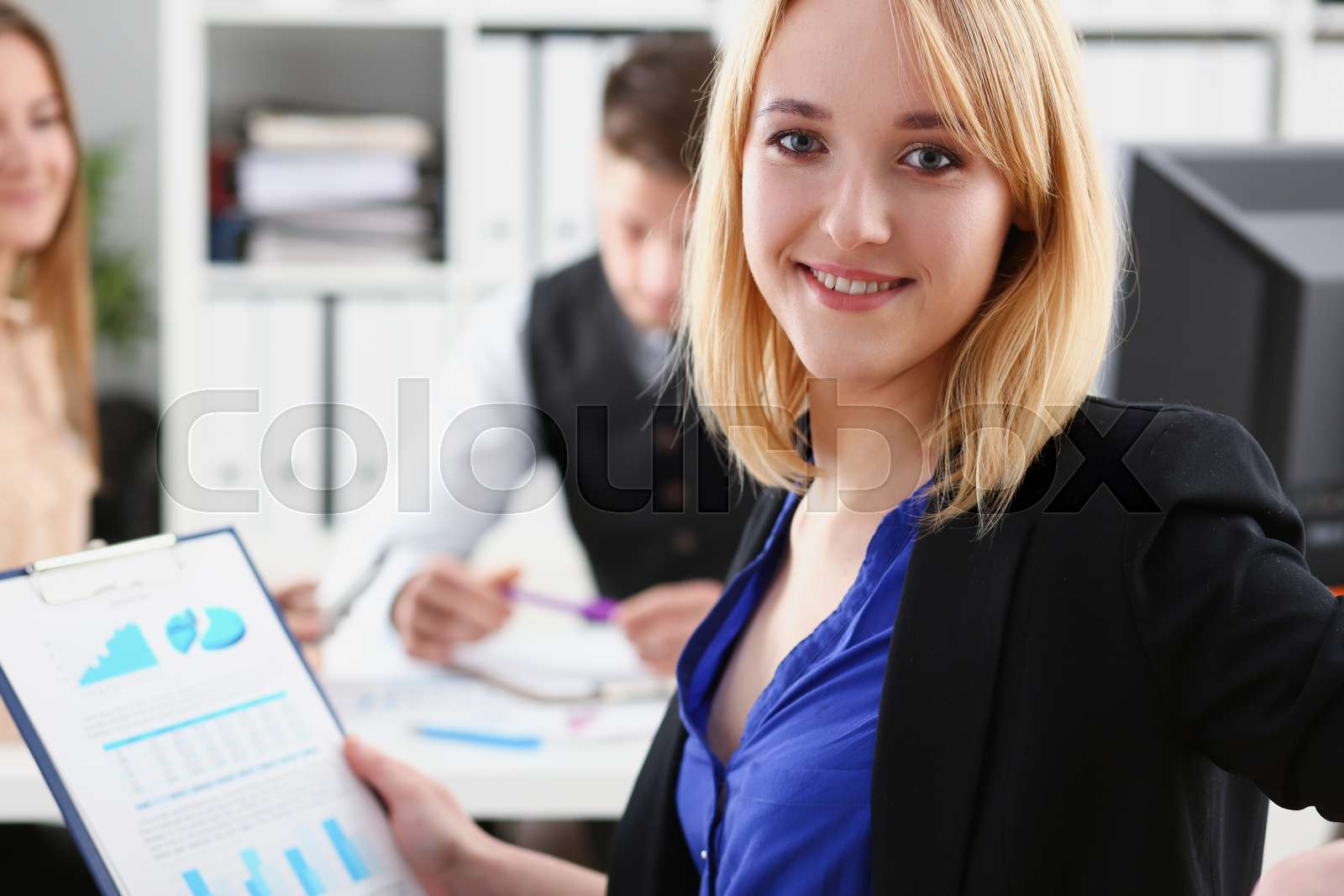 Beautiful smiling cheerful girl at workplace | Stock image | Colourbox