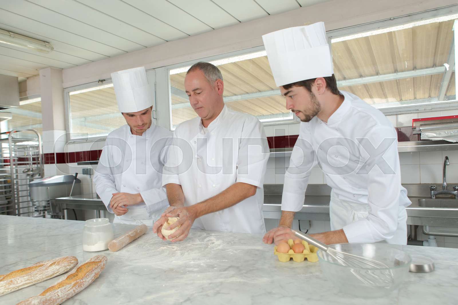 baker and assistants in the kitchen of the bakery | Stock image | Colourbox