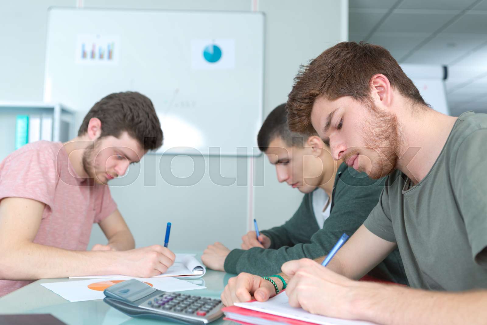 students writing something during conference | Stock image | Colourbox